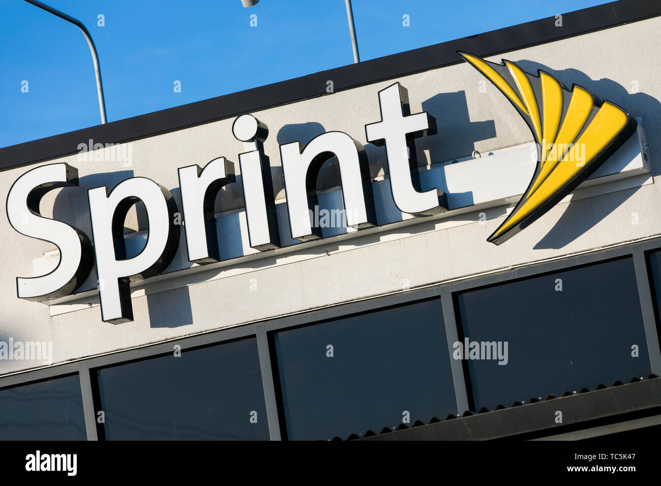 A logo sign outside of a Sprint Corporation retail store location in ...
