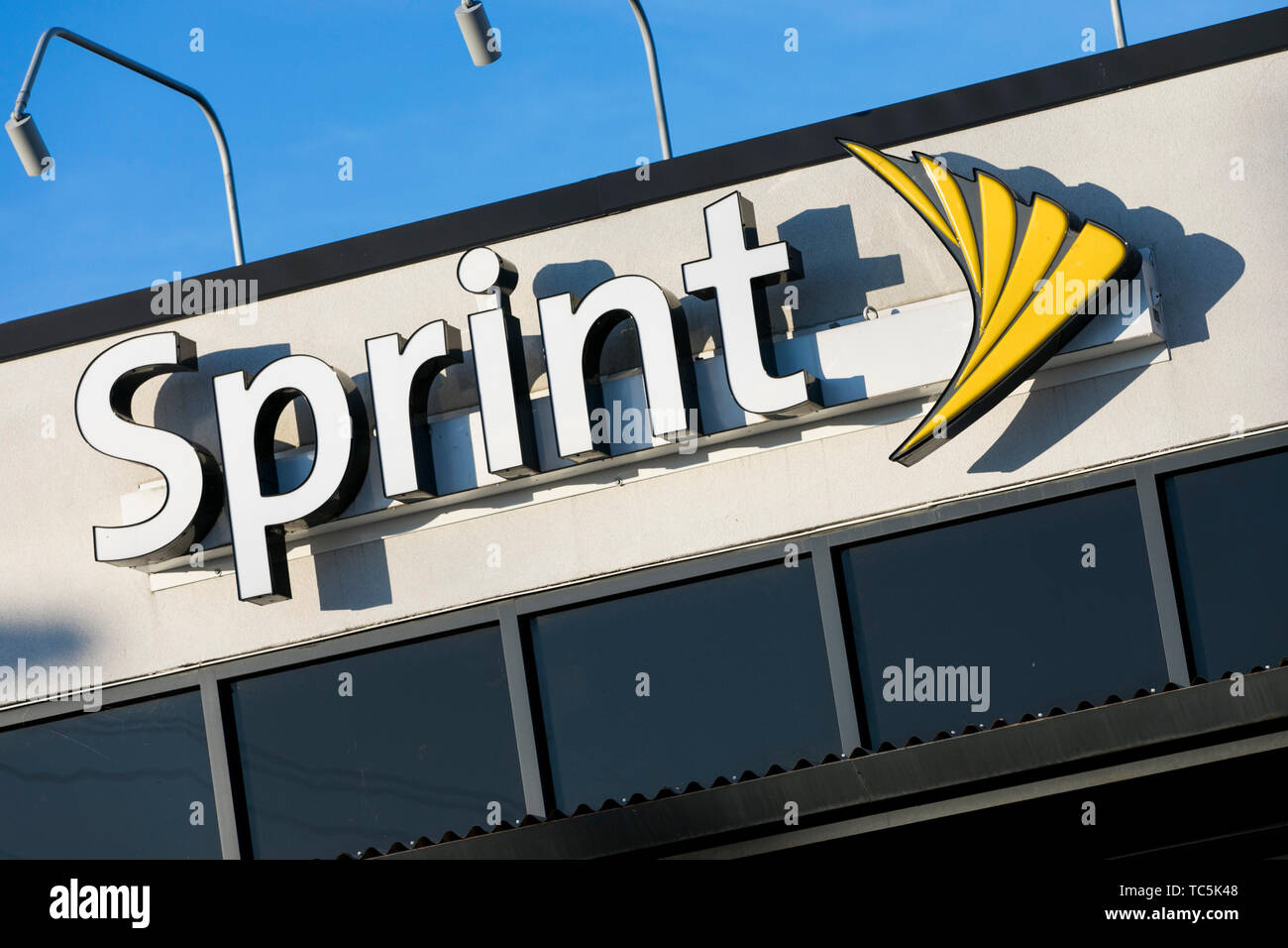 A logo sign outside of a Sprint Corporation retail store location in ...