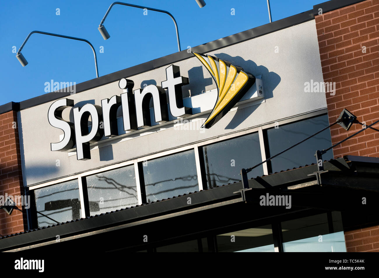 A logo sign outside of a Sprint Corporation retail store location in ...