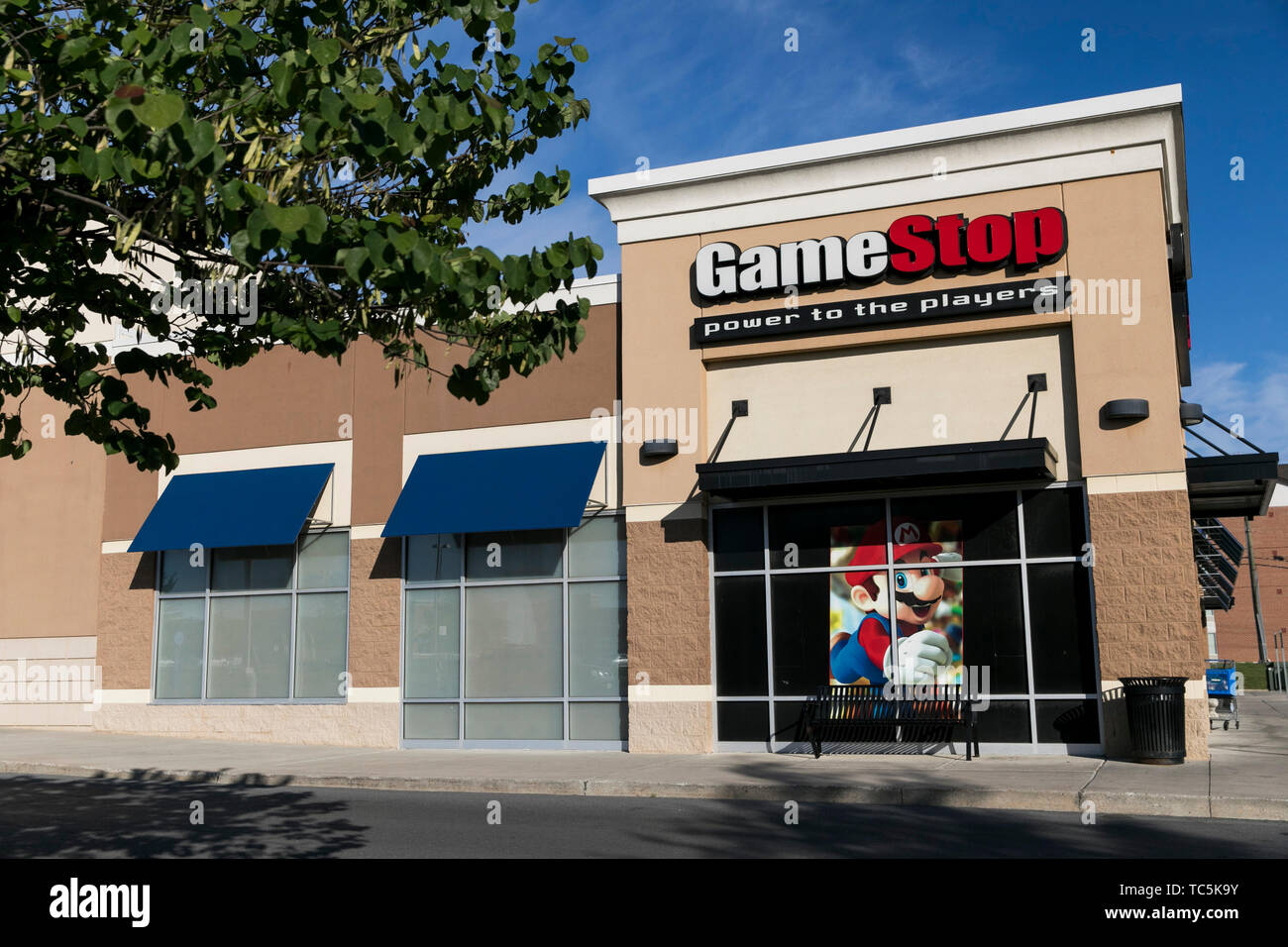 A logo sign outside of a GameStop retail store location in Martinsburg ...