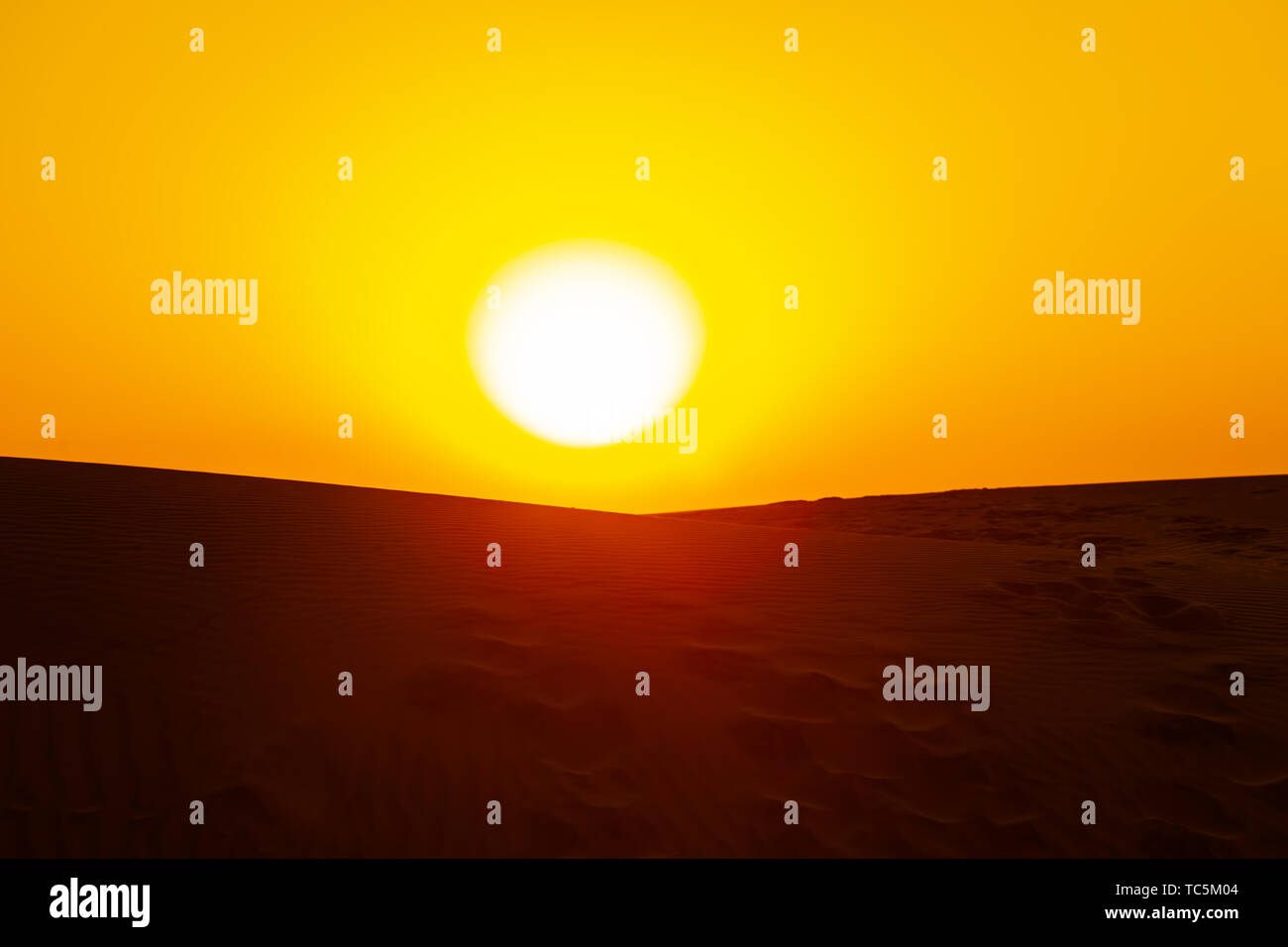 Sunset in the desert Stock Photo - Alamy