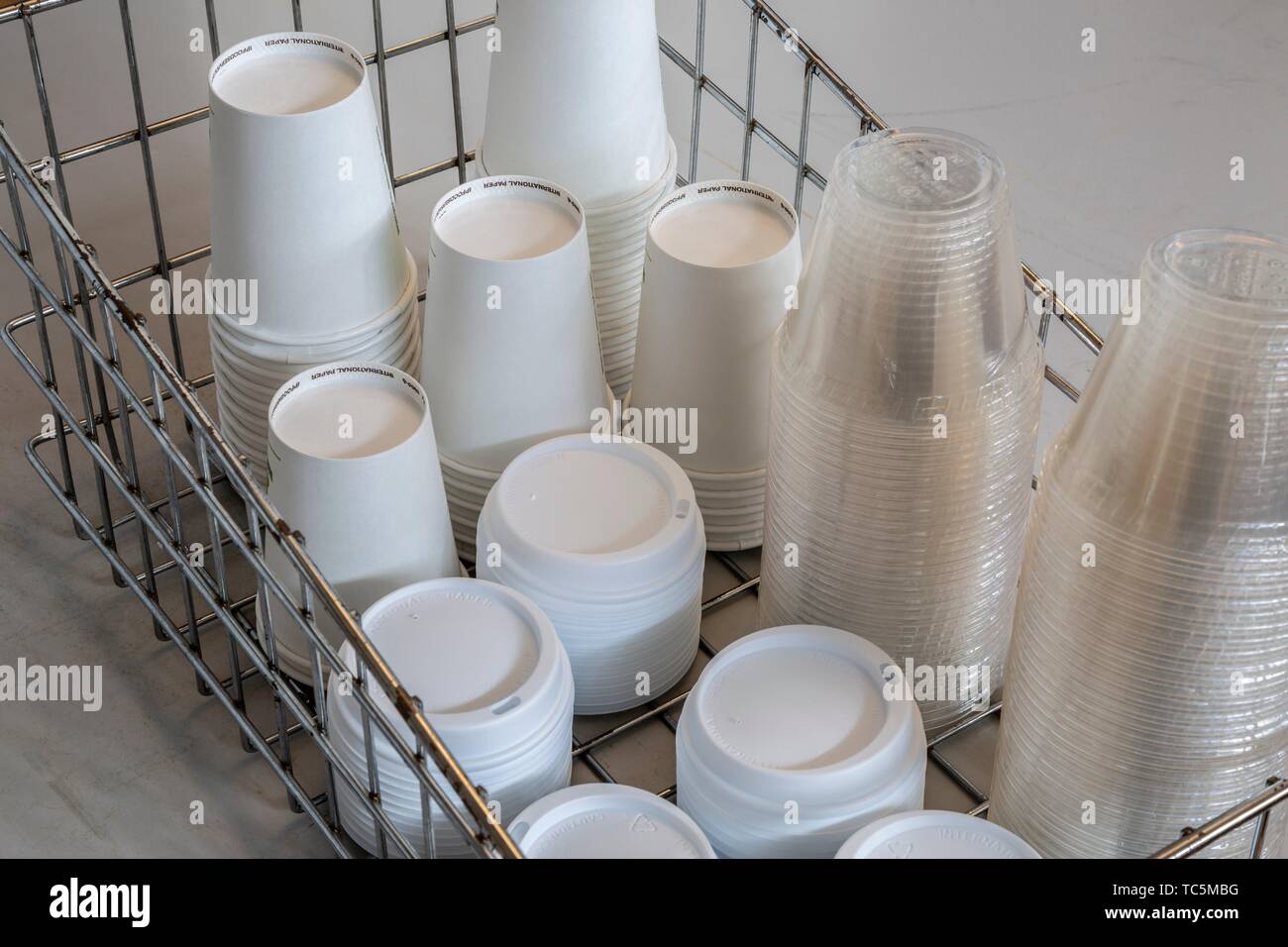 Stacks of plastic and paper cups and lids in a metal container Stock ...