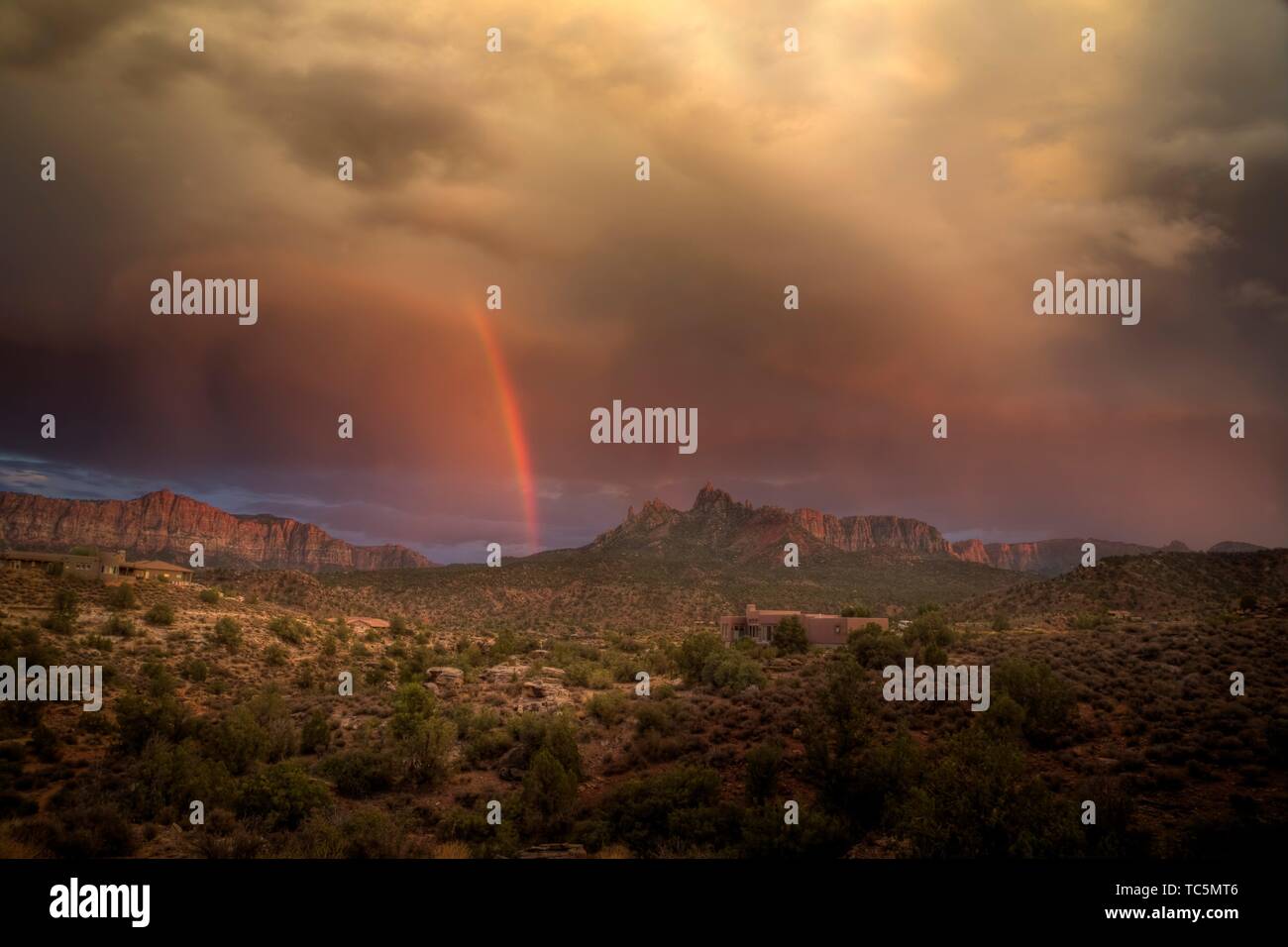 A rainbow appears during a monsoonal thunderstorm at Zion National Park ...