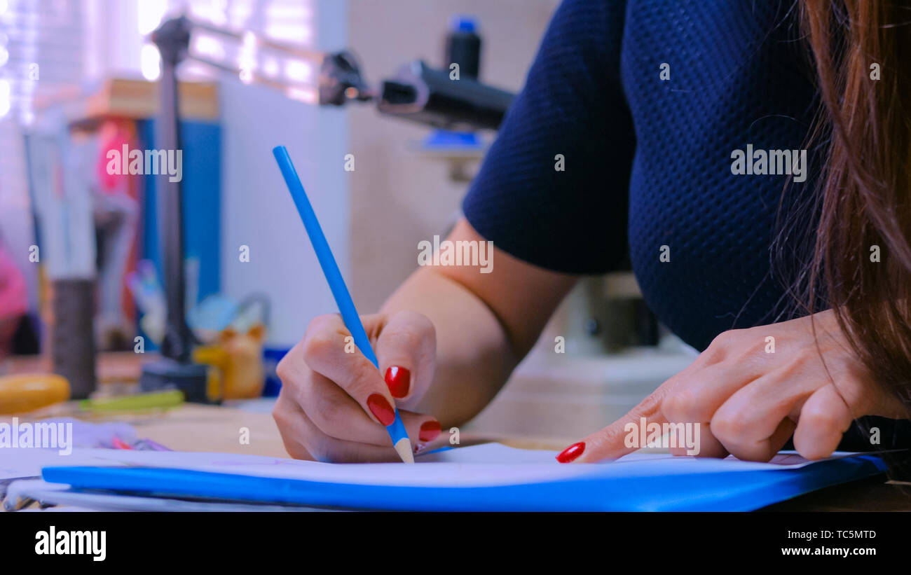 Fashion designer drawing design sketch Stock Photo - Alamy