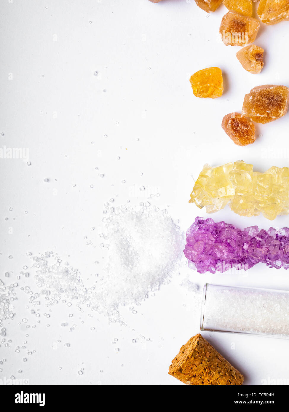 Various different types of sugar, in flask on white background, copy ...