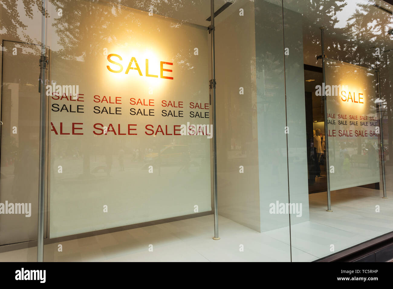 sale poster in the displaywindow of shop Stock Photo - Alamy