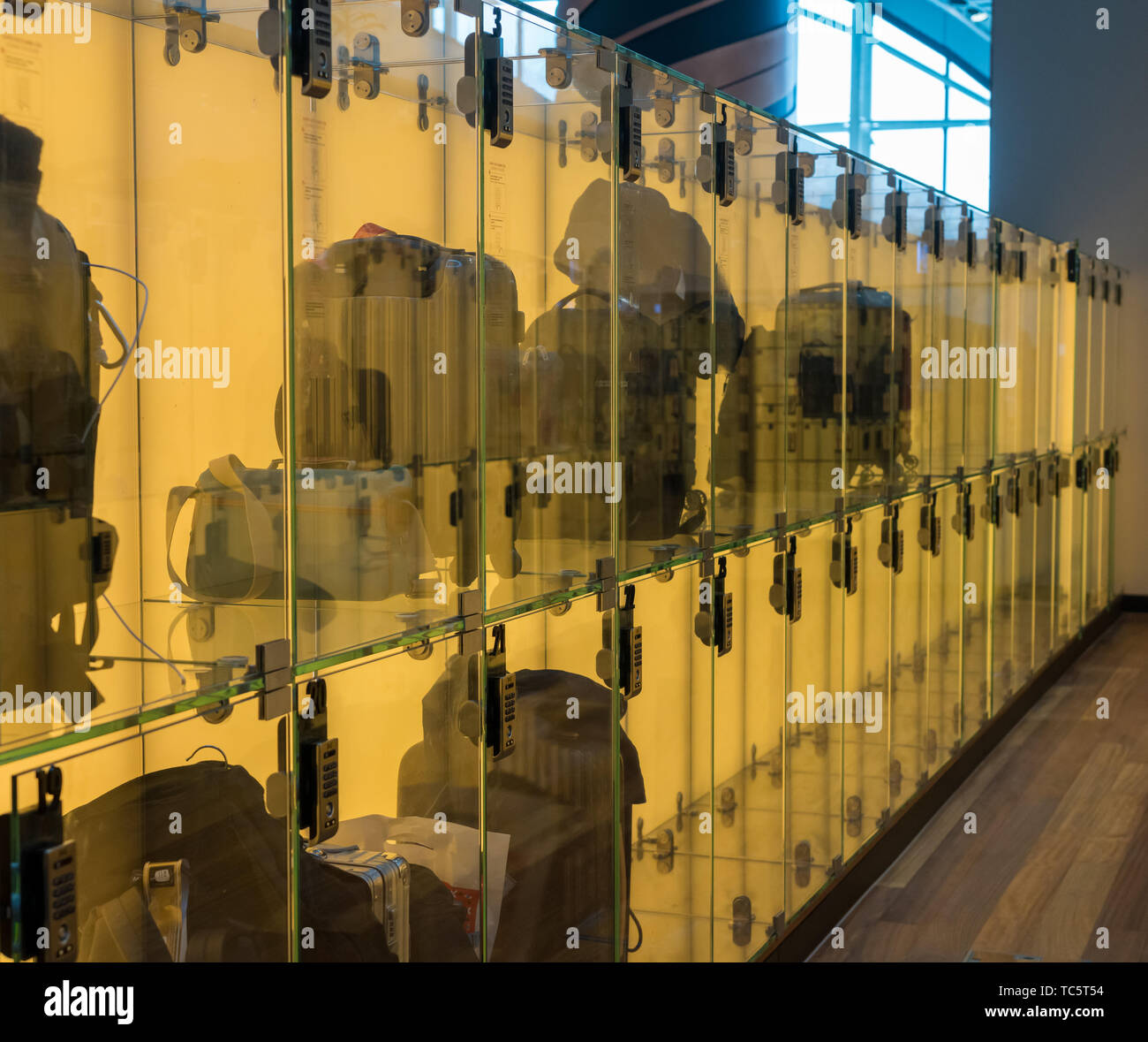 Luggage stored in transparent glass boxes in airport lounge Stock Photo ...