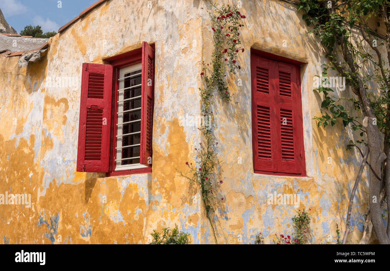 Red shutters on window in ancient district of Anafiotika in Athens ...