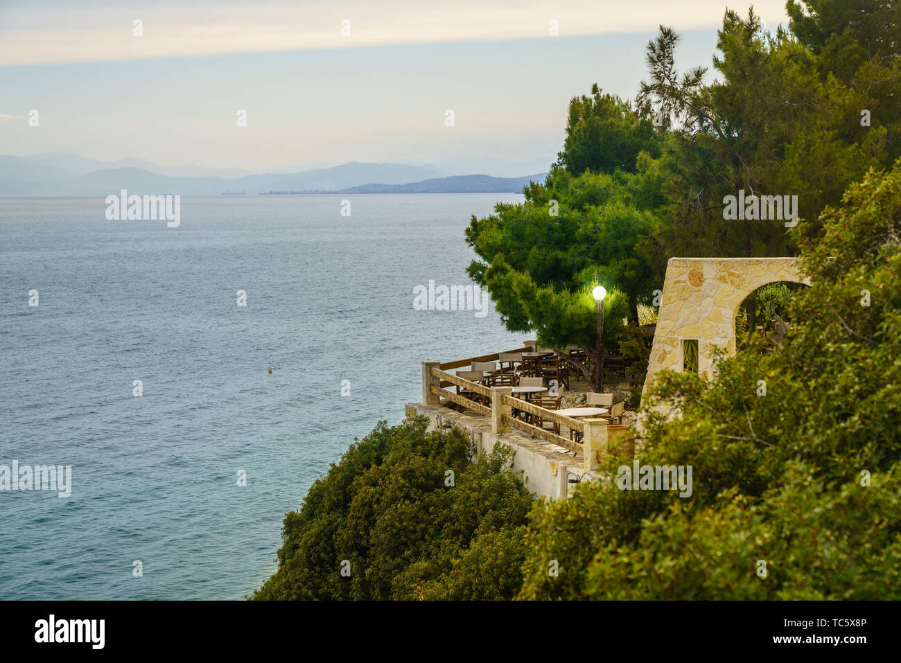 Stone terrace of restaurant on cliff side overlooking ocean Stock Photo ...