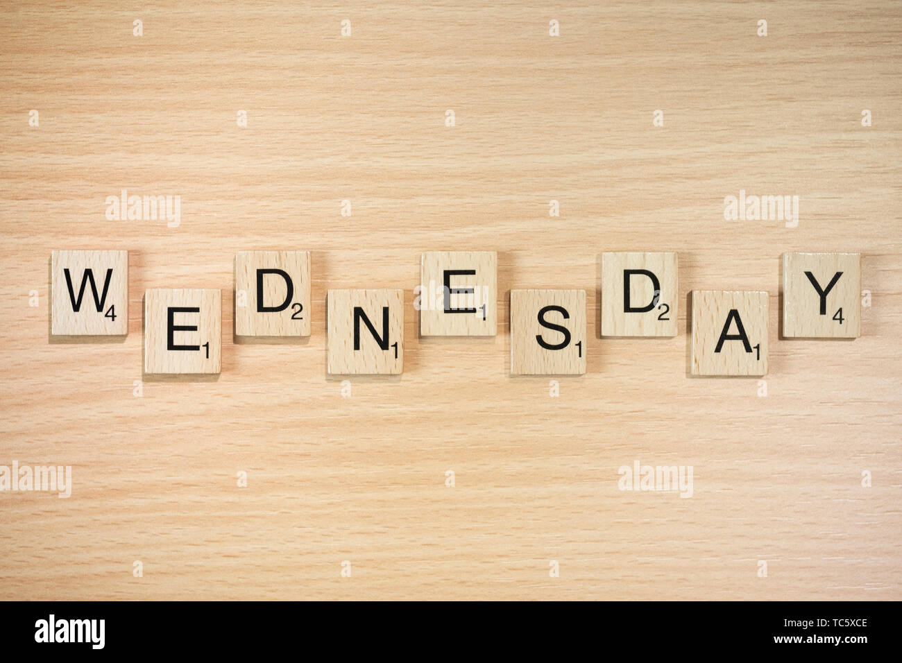 The word Wednesday, spelt out using wooden tiles on a wood effect ...