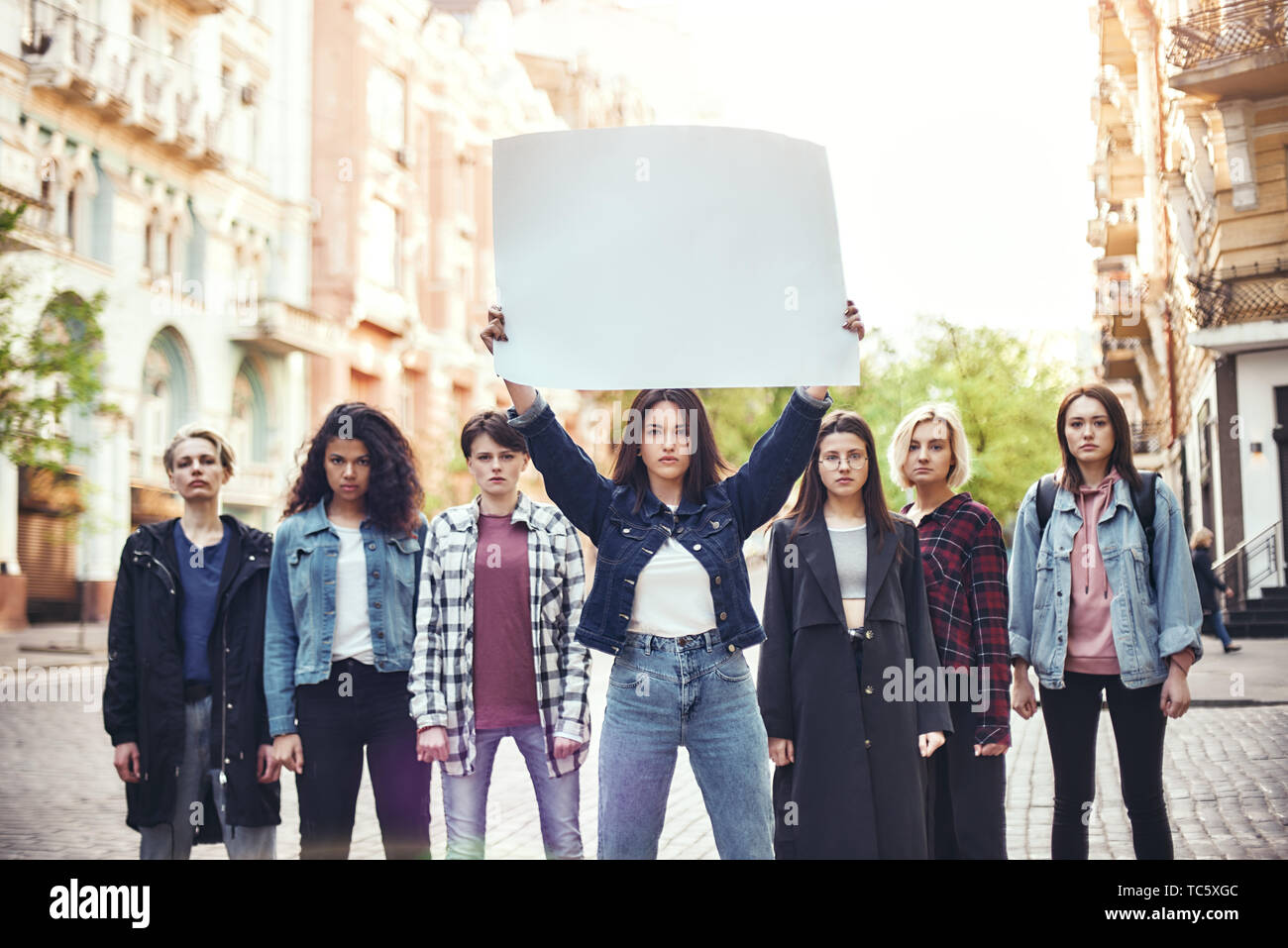 Girl power. Group of young women standing on the road during protest ...