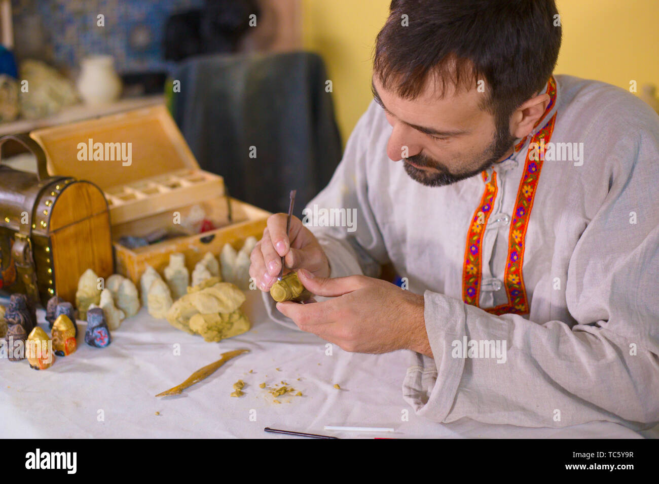 Potter making clay figure for board game Stock Photo - Alamy