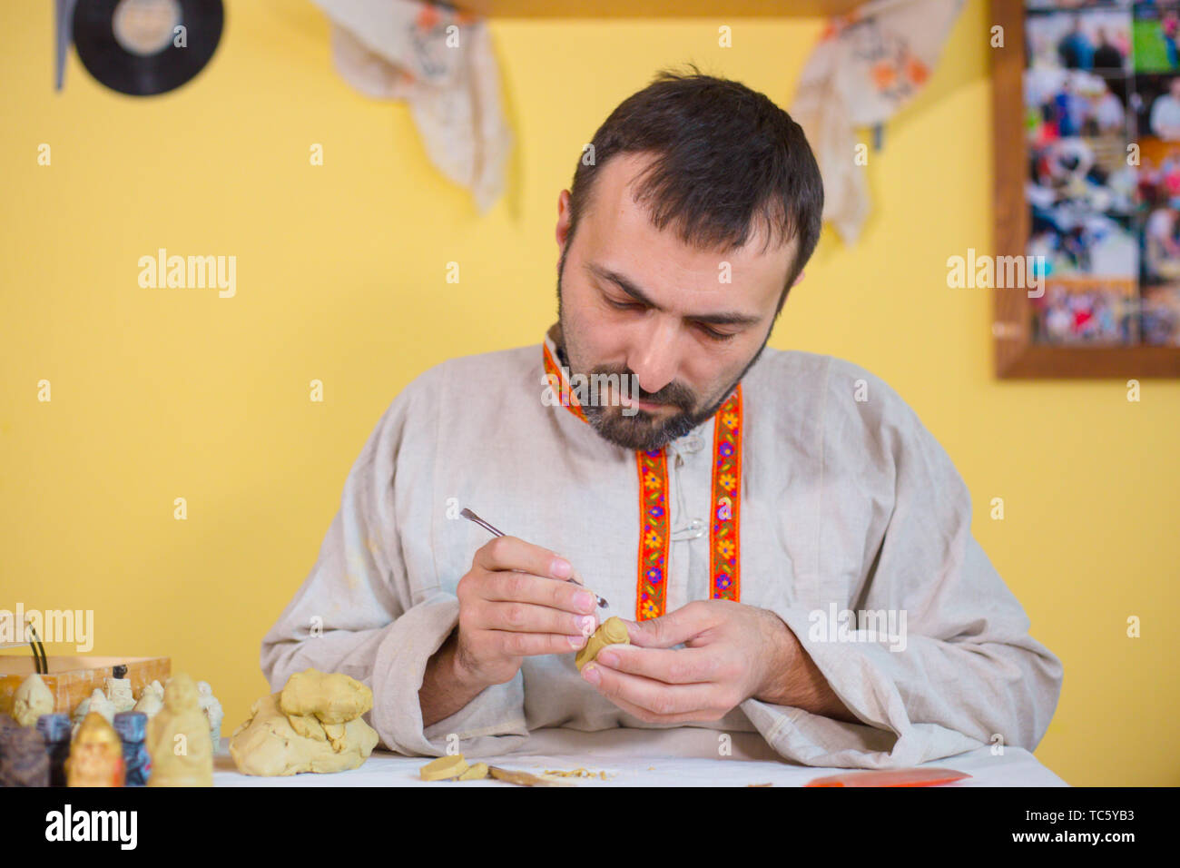 Potter making clay figure for board game Stock Photo - Alamy