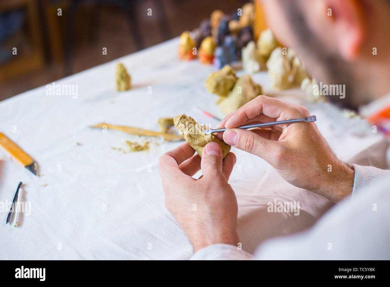 Potter making clay figure for board game Stock Photo - Alamy