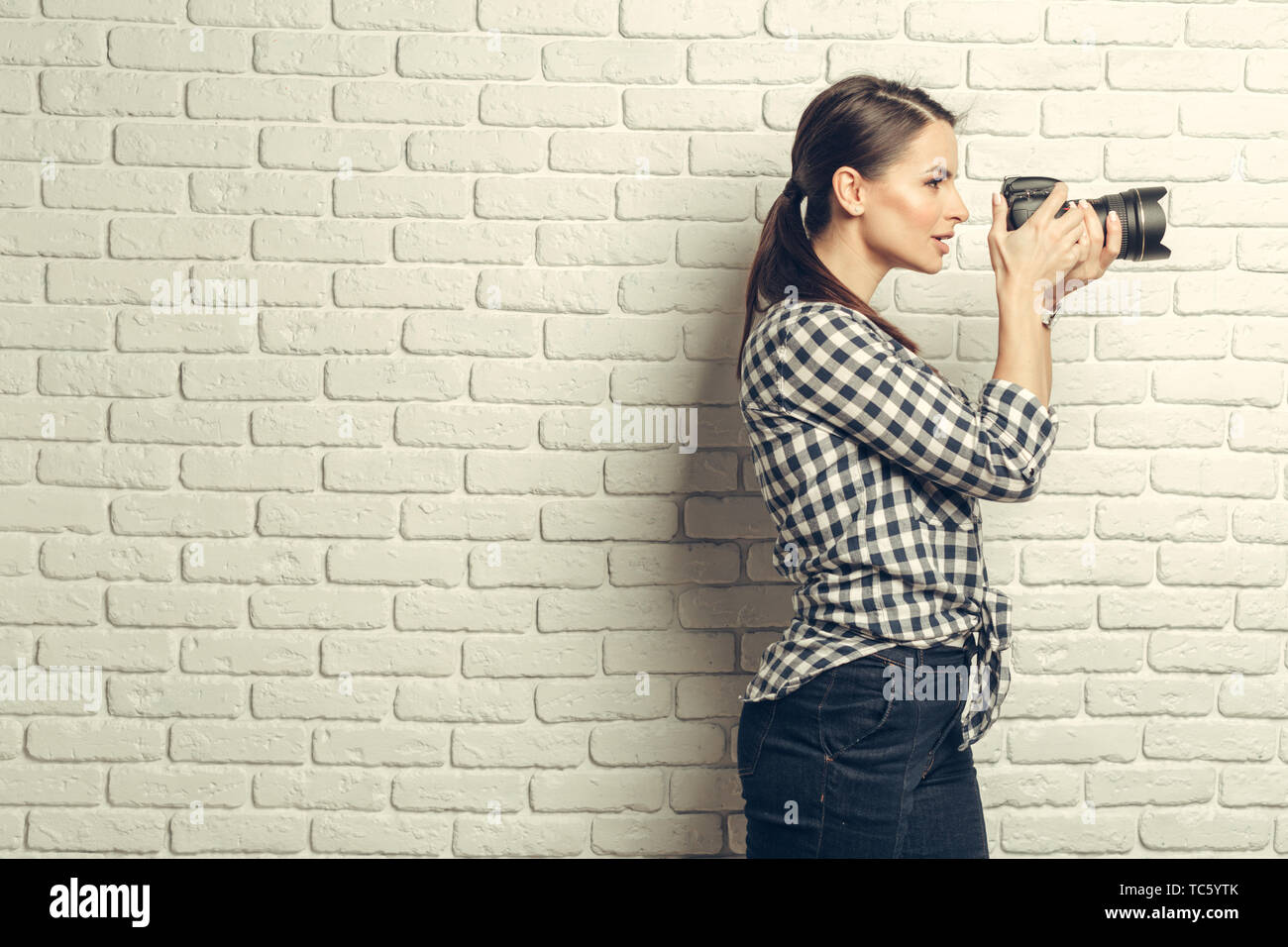 Pretty woman is a professional photographer with dslr camera Stock ...