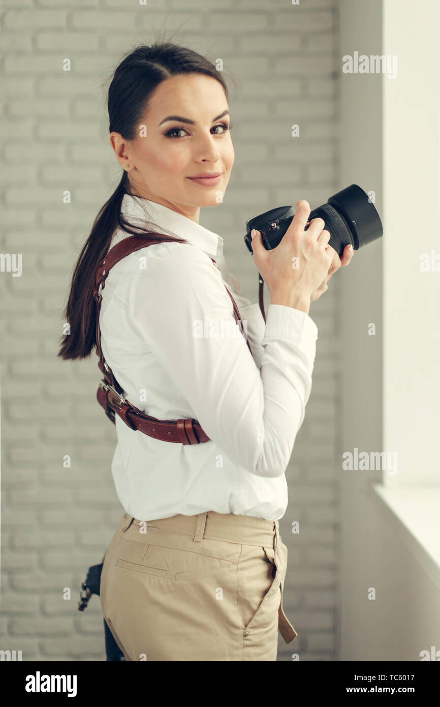 Pretty woman is a professional photographer with dslr camera Stock ...