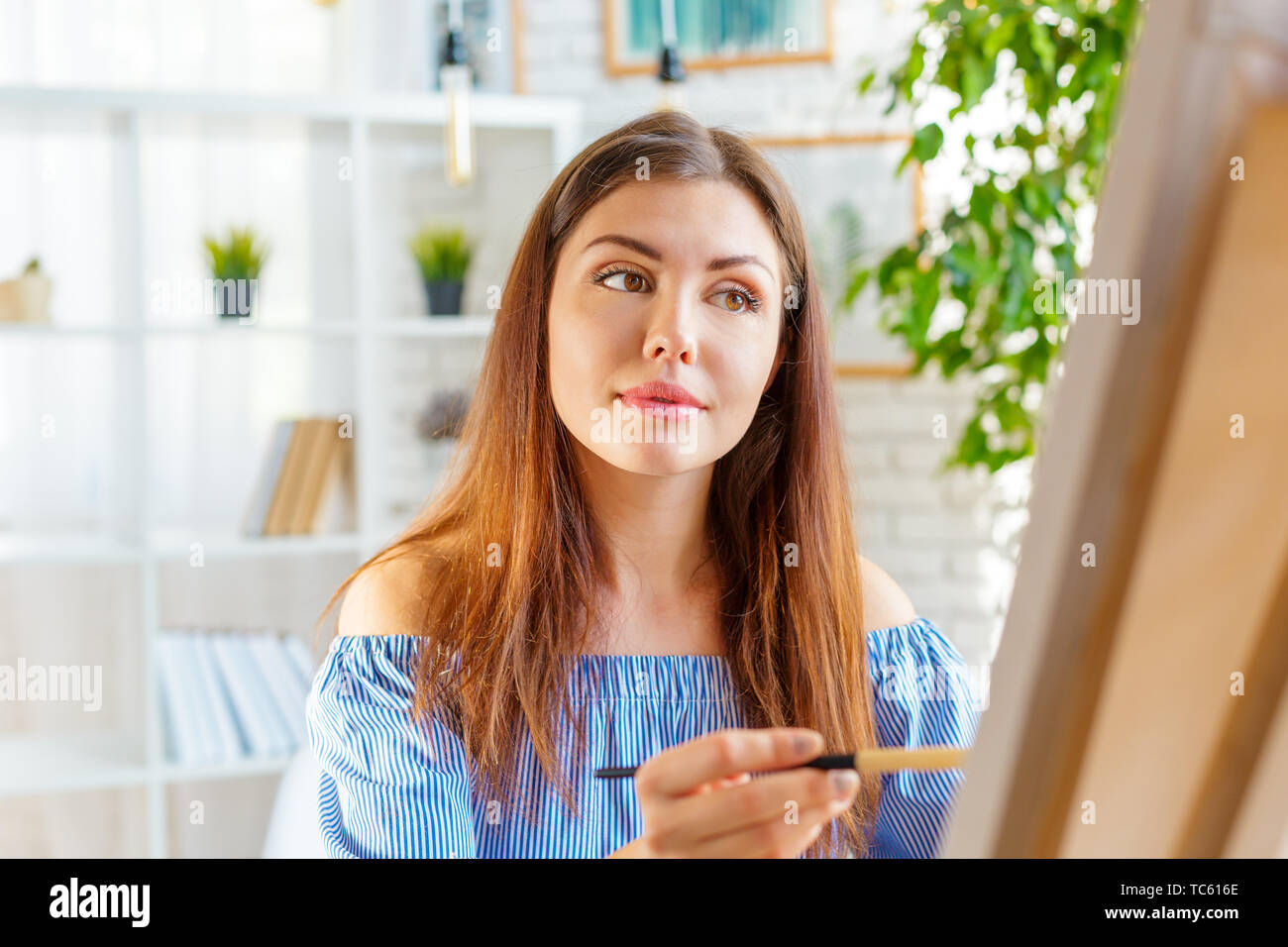 Creative woman working in art studio Stock Photo - Alamy