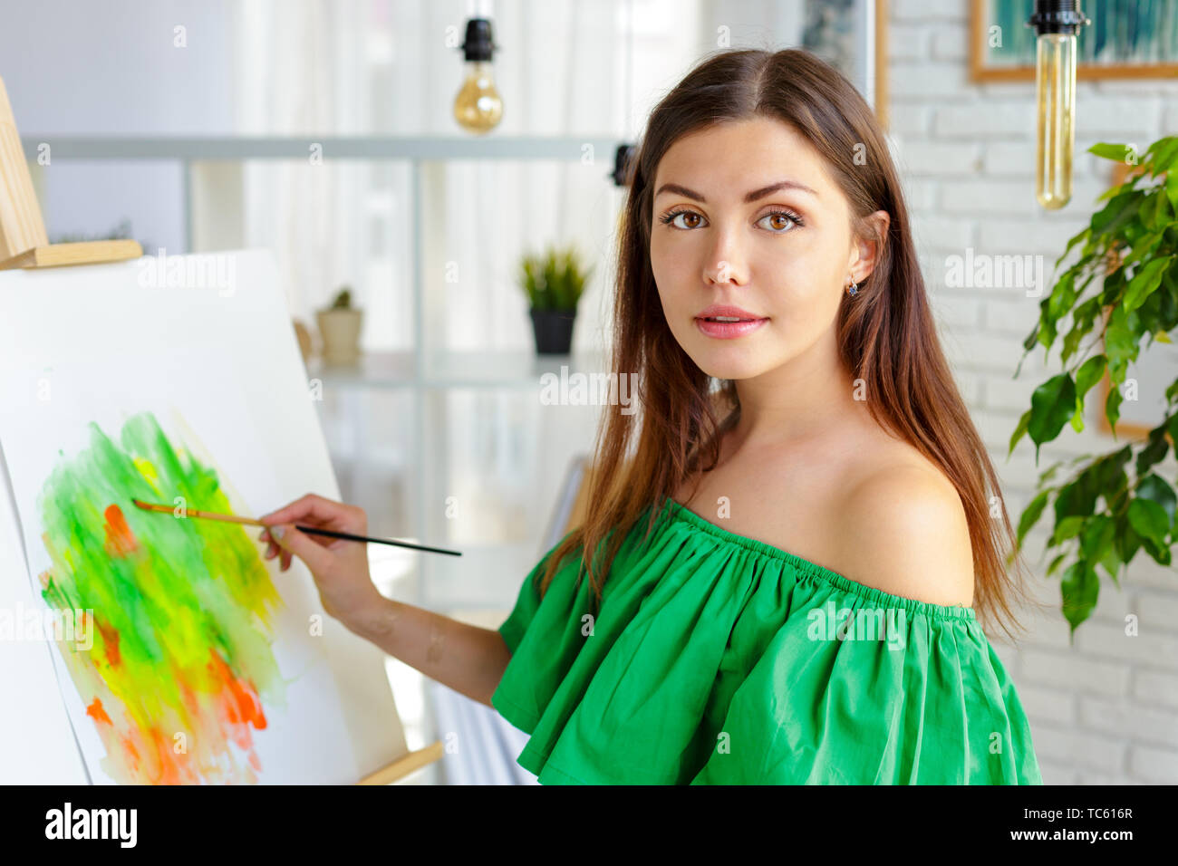 Creative woman working in art studio Stock Photo - Alamy