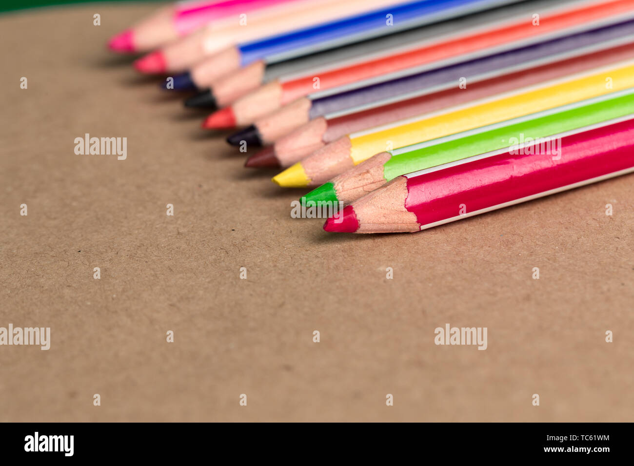 Note book and colored pencils Stock Photo - Alamy