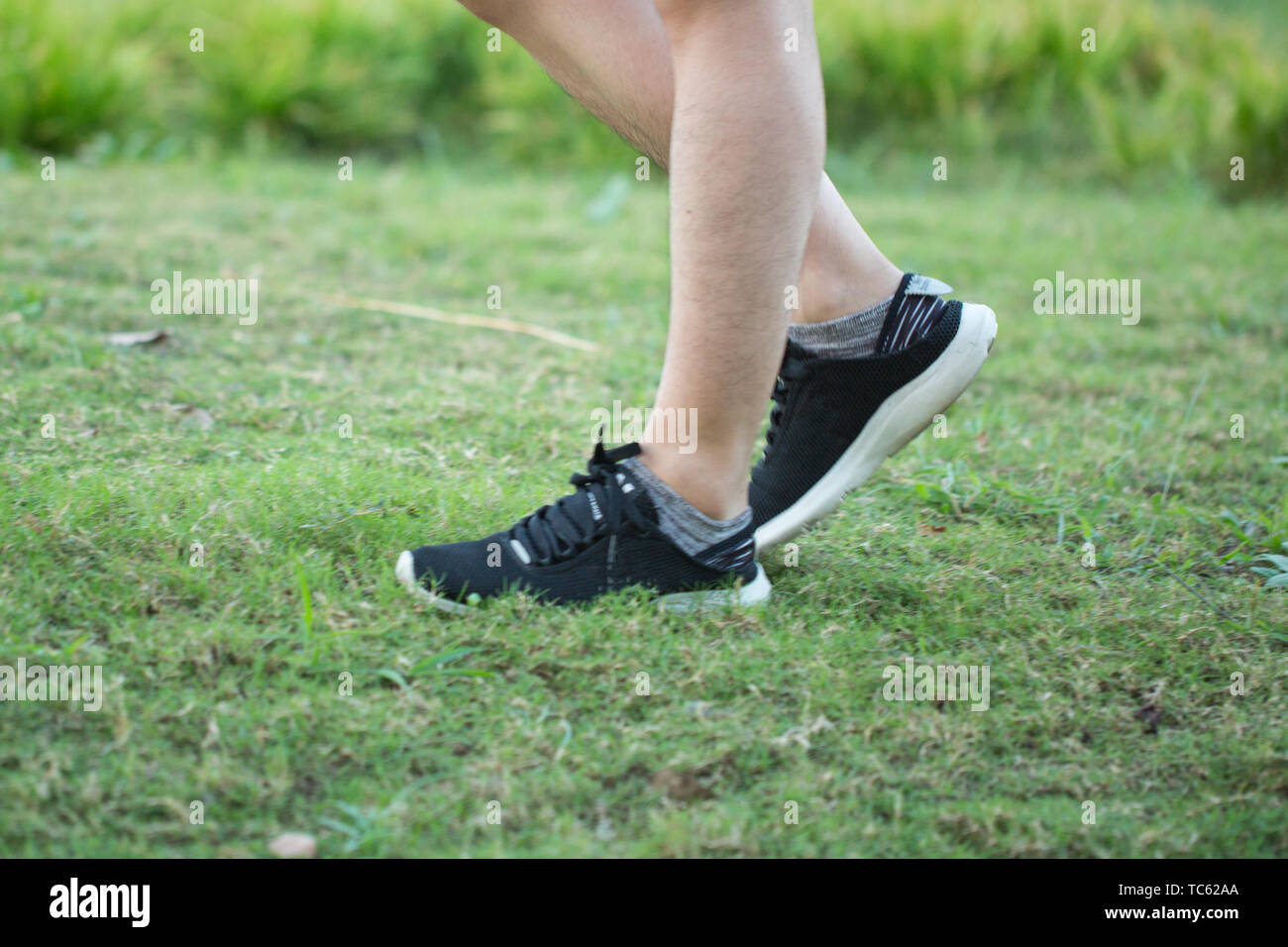 Man running on grass Stock Photo - Alamy