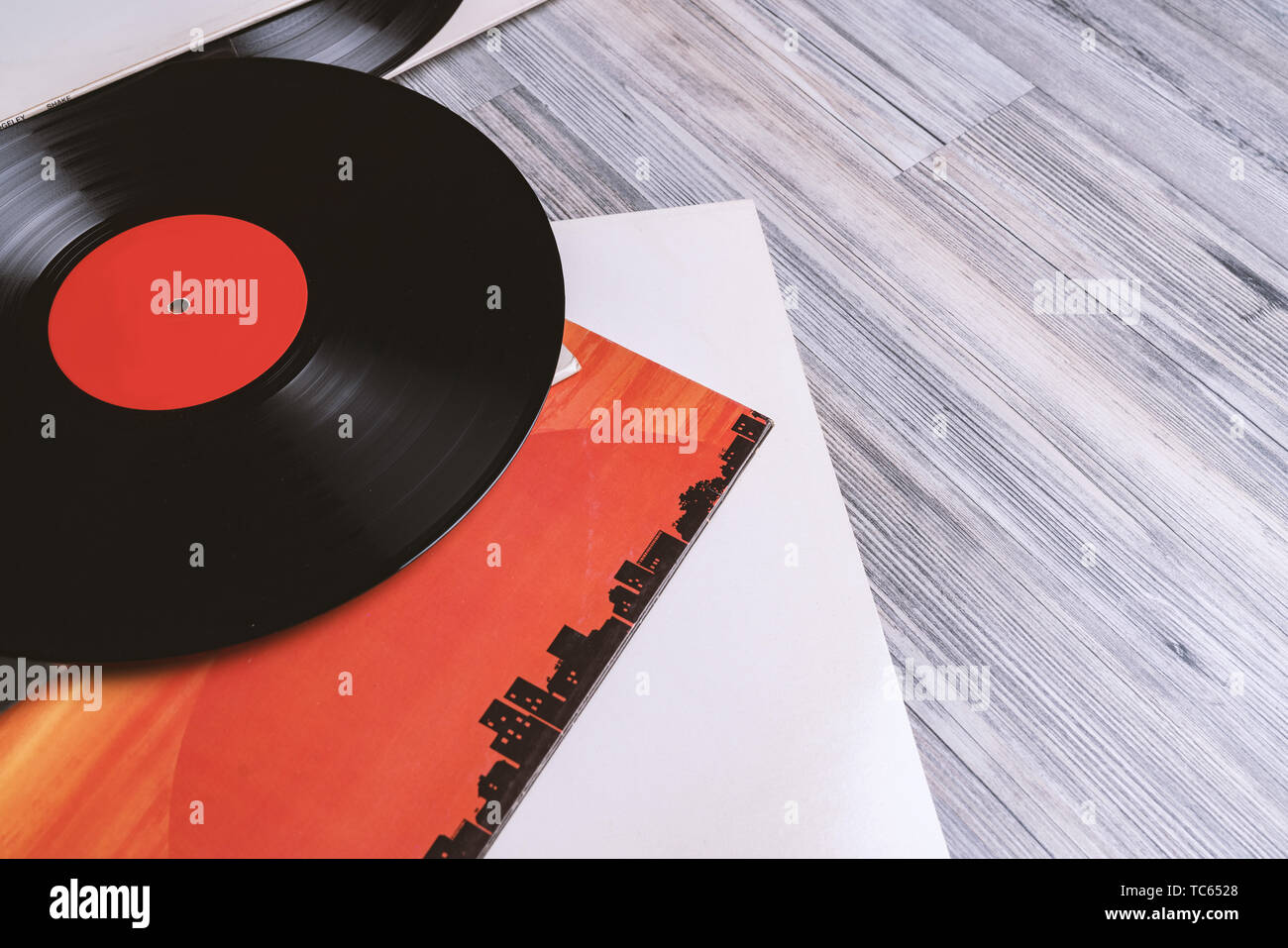 Black vinyl record and covers album on the background of their gray ...