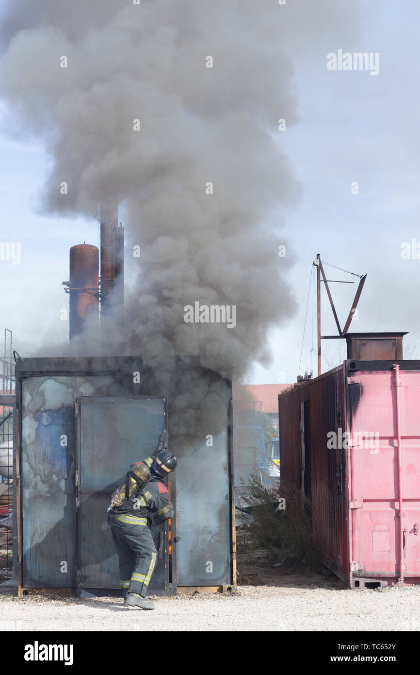 Firefighter putting out fire training station extinguisher backdraft ...