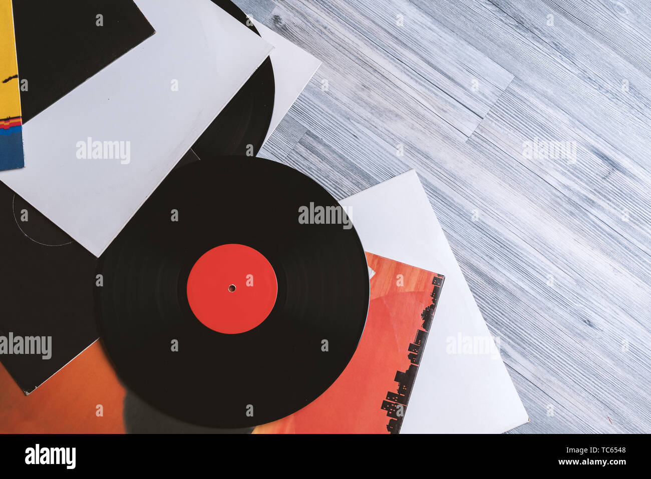 Black vinyl record and covers album on the background of their gray ...