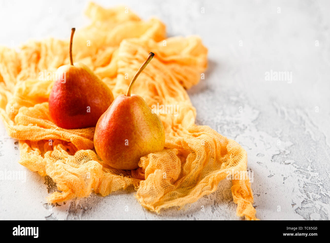 Fresh bio yellow and red pears on the grey background. Space for text ...