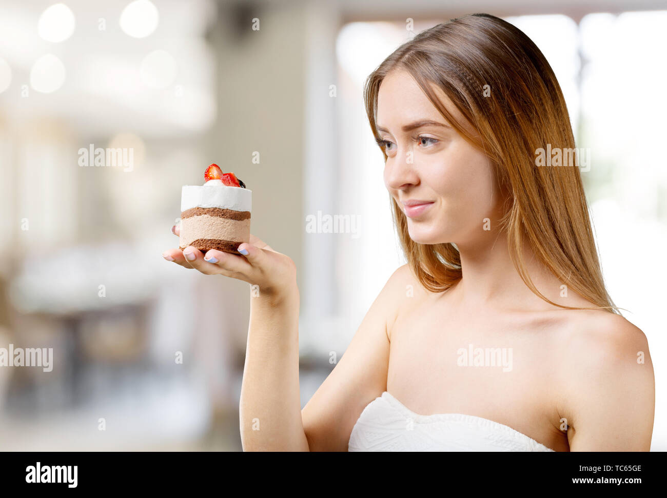 Beautiful young woman with a cake Stock Photo - Alamy