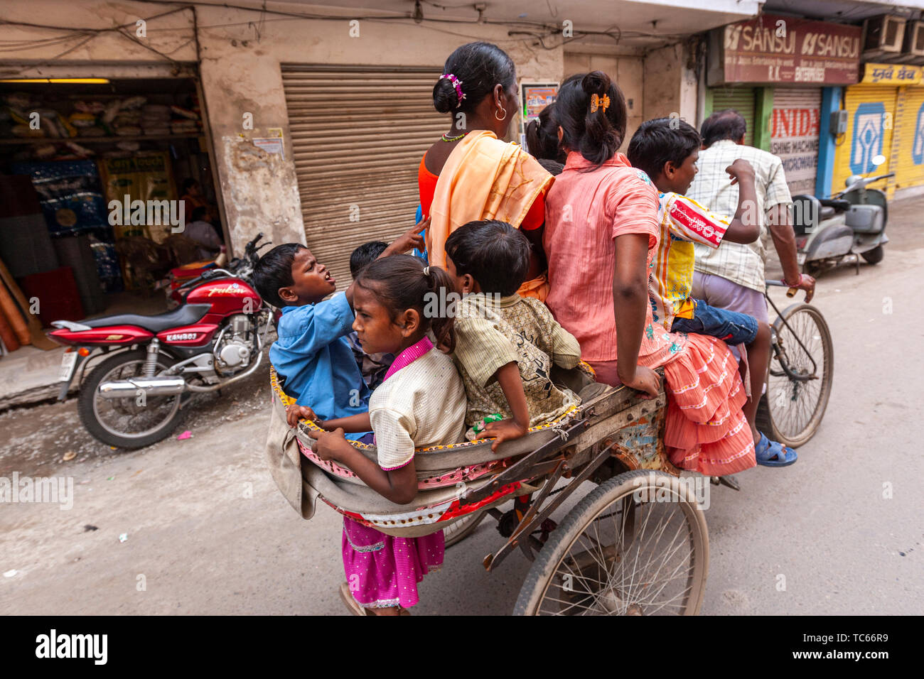 Children packed in a bicycle rickshaw in Market in Amritsar, Punjab ...