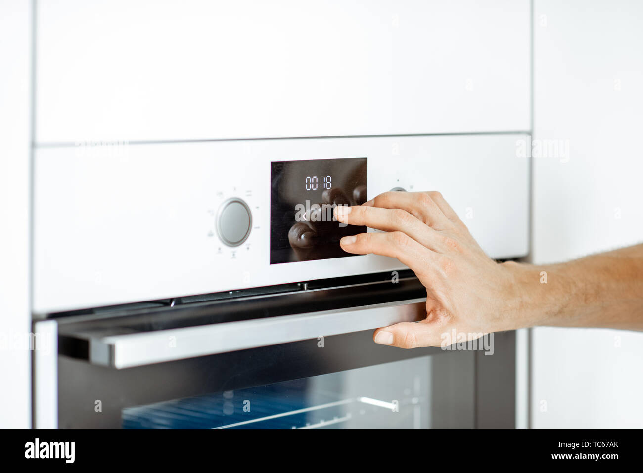 Setting up electric oven on the kitchen at home, close-up view Stock ...