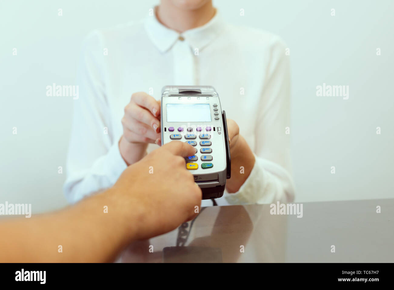 Guest at hotel reception paying with check during check-in Stock Photo ...