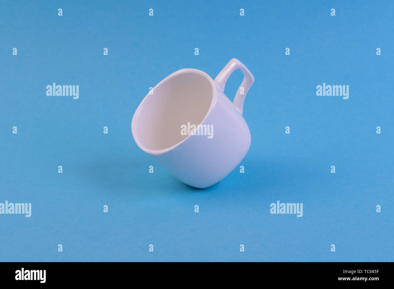 Ceramic isolated coffee mug side view. White teacup on pastel blue ...