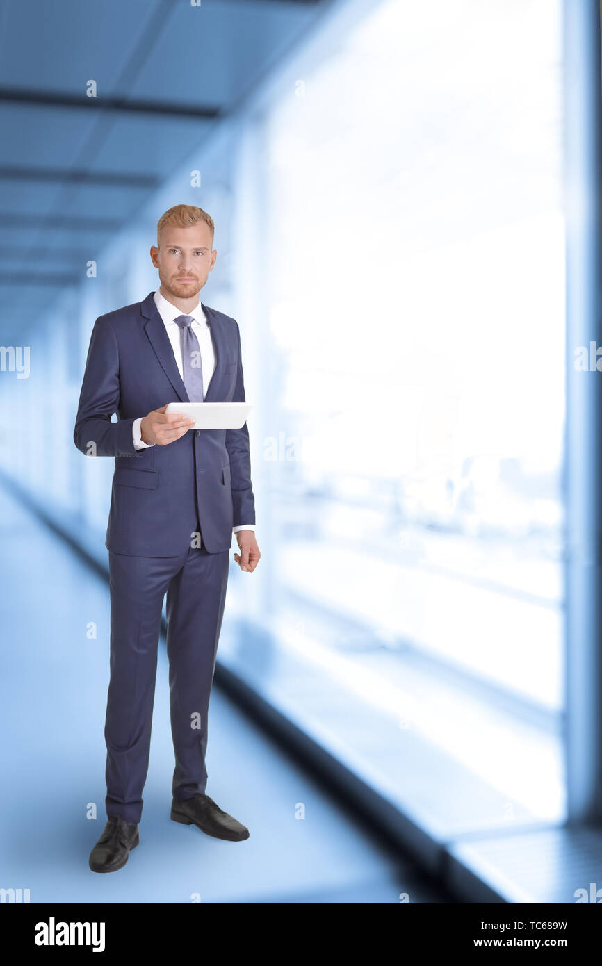 Real estate or insurance agent in suit and tie standing in front of ...