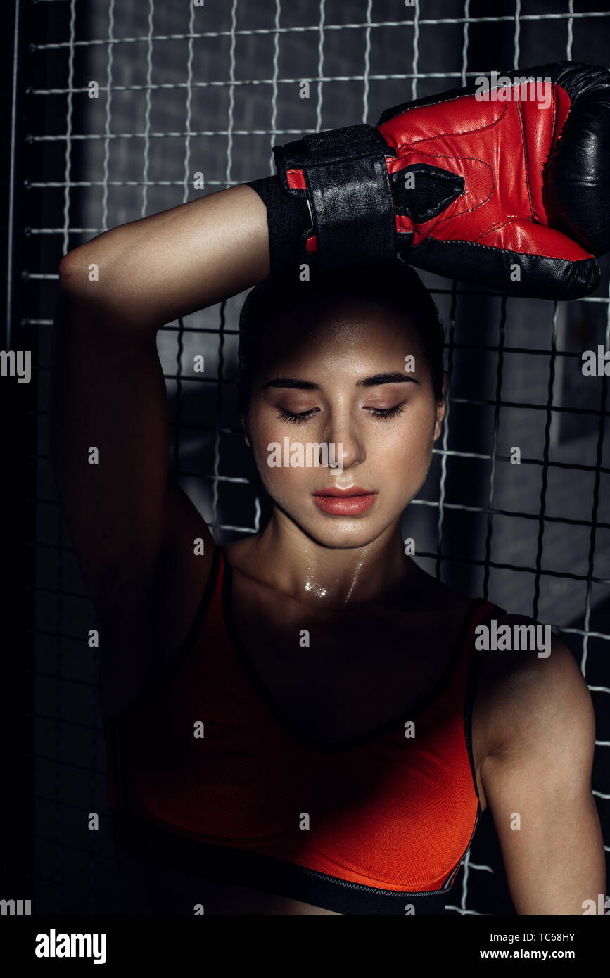Pensive attractive boxer in red boxing glove looking down Stock Photo ...