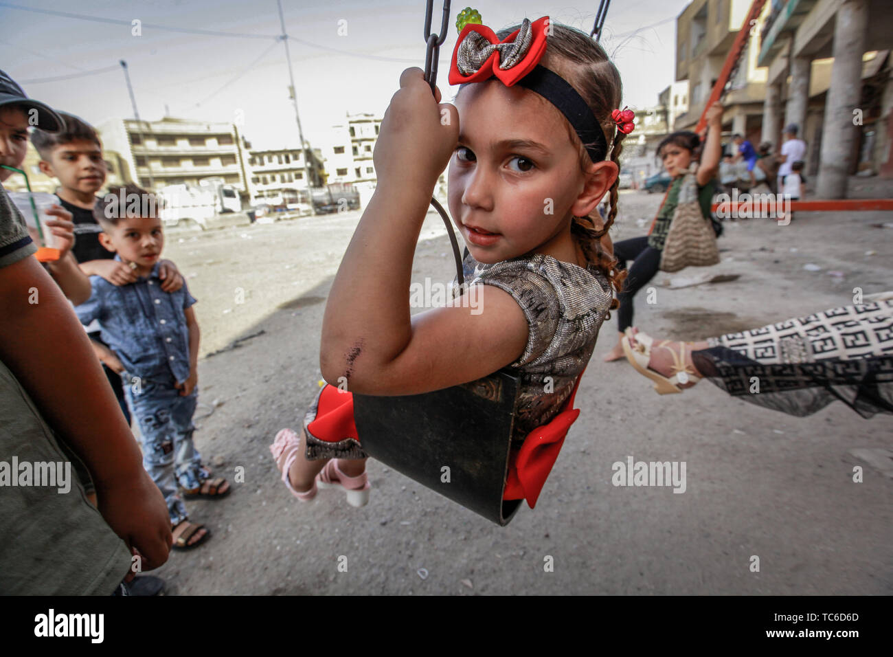 Baghdad, Iraq. 05th June, 2019. An Iraqi girl sits on a swing during ...