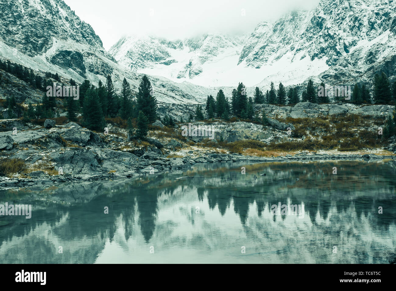 Mountain lake, rocks are reflected in water surface Stock Photo - Alamy