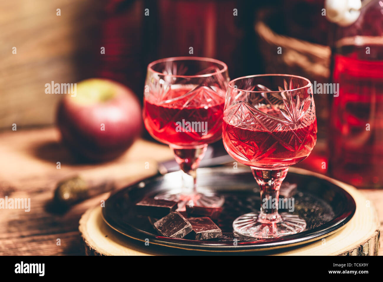 Homemade berry alcoholic beverage and chocolate bars on metal tray ...