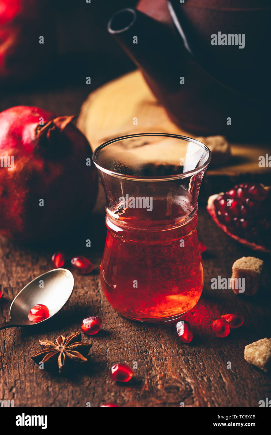 Black tea with pomegranate seeds and some spices on rustic table Stock ...