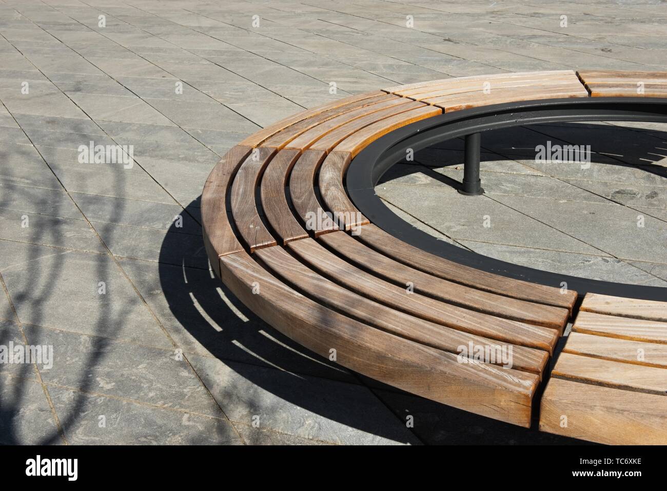 Wooden modern trendy design round circular park bench Stock Photo - Alamy