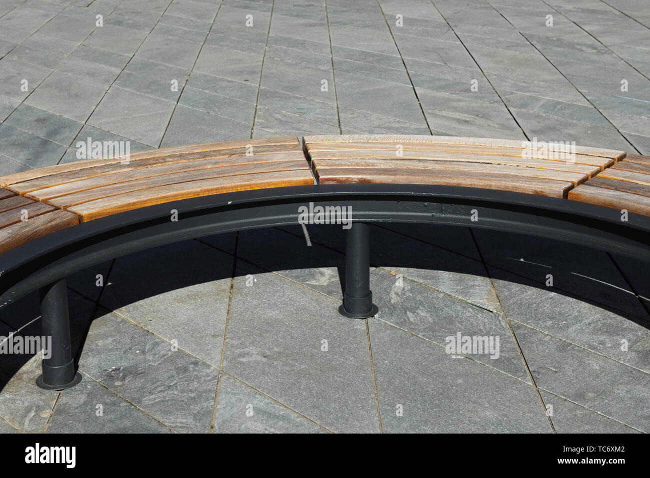 Wooden modern trendy design round circular park bench Stock Photo - Alamy