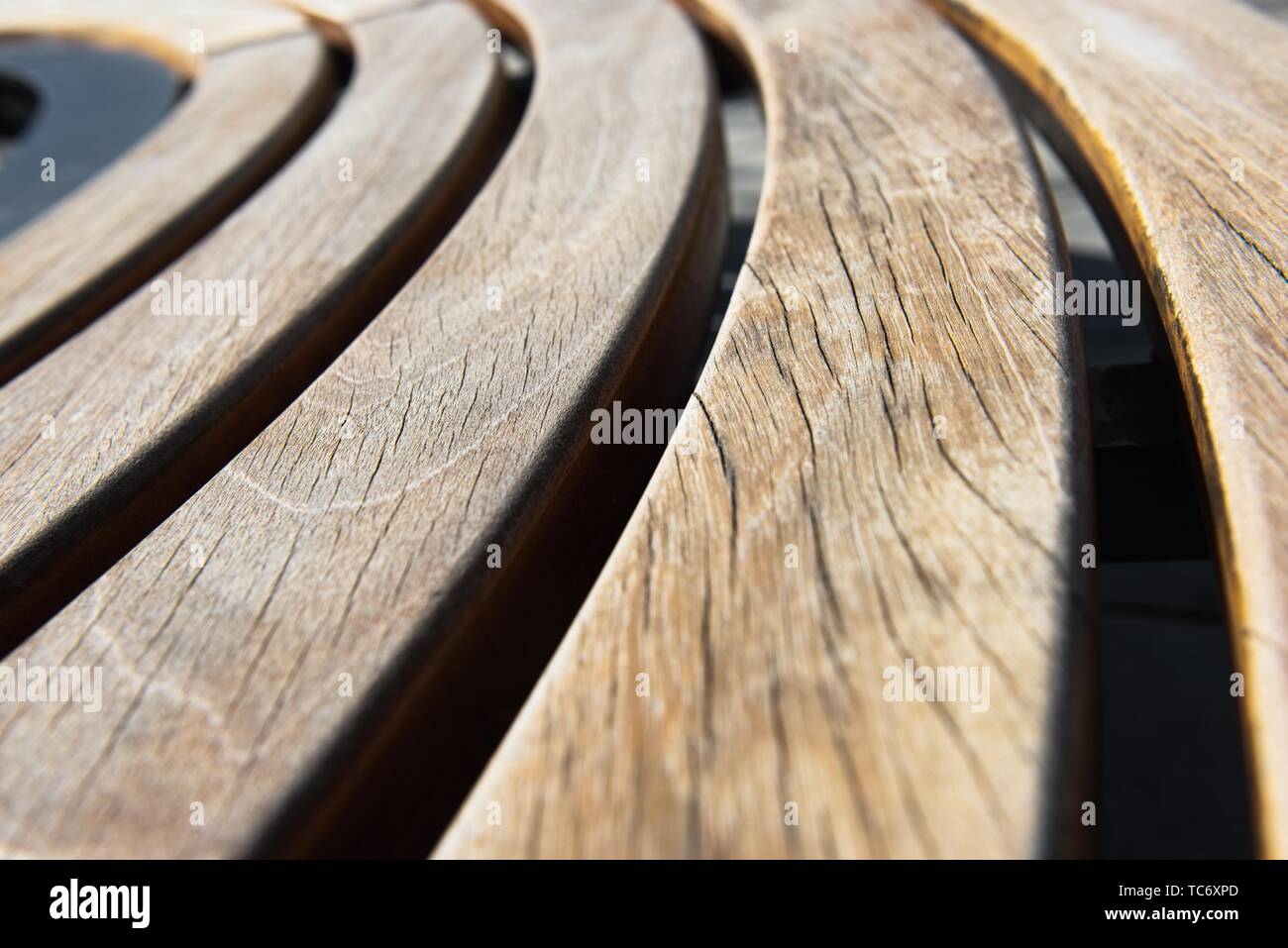 Wooden modern trendy design round circular park bench Stock Photo - Alamy