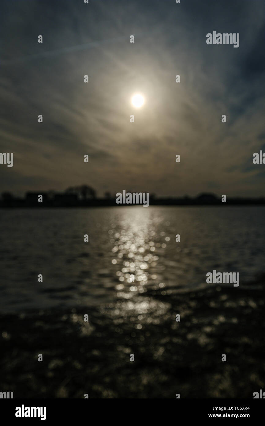 sunset light reflection in the beach wet sand and water. abstract ...