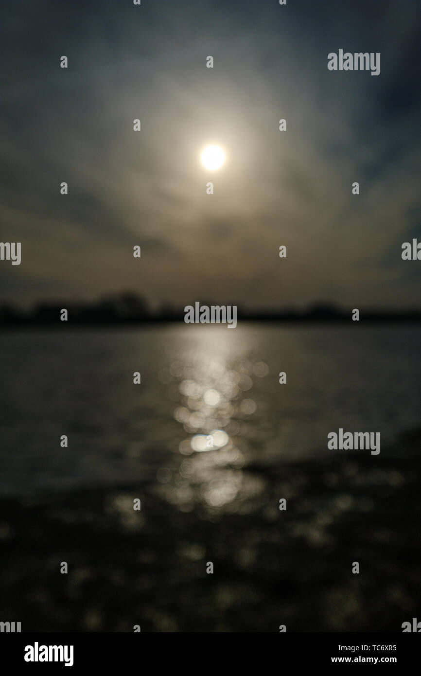 sunset light reflection in the beach wet sand and water. abstract ...