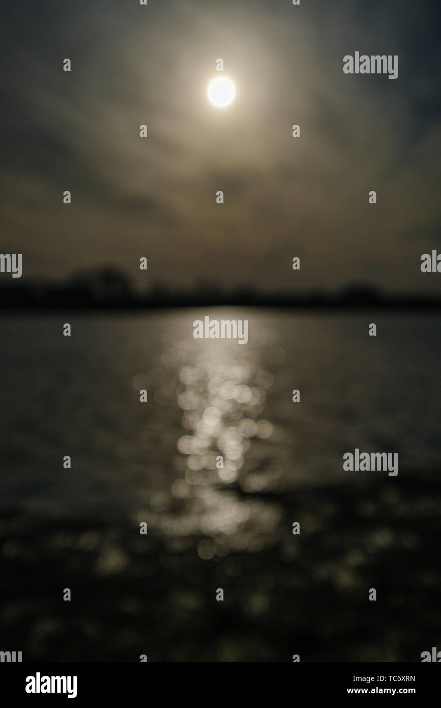 sunset light reflection in the beach wet sand and water. abstract ...