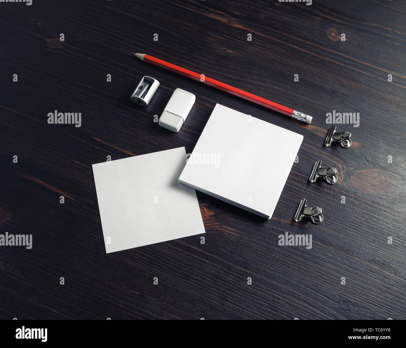 White square notes, pencil, eraser and sharpener on wooden background ...