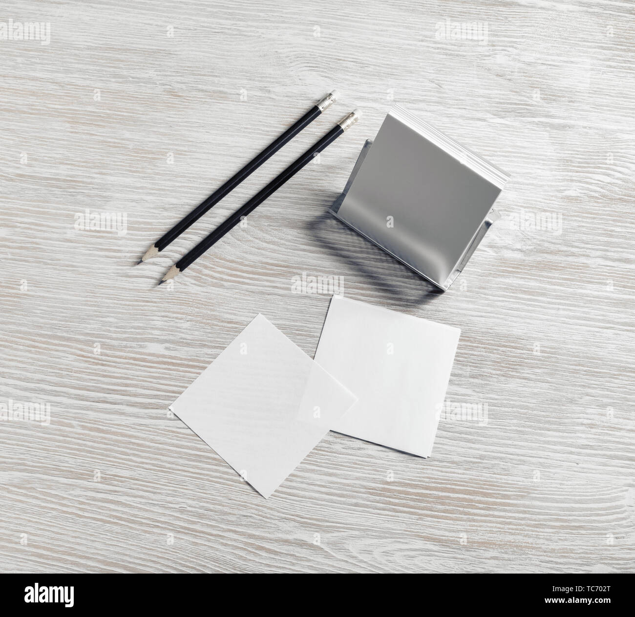 Blank stationery on light wood table background. Notes and pencils ...