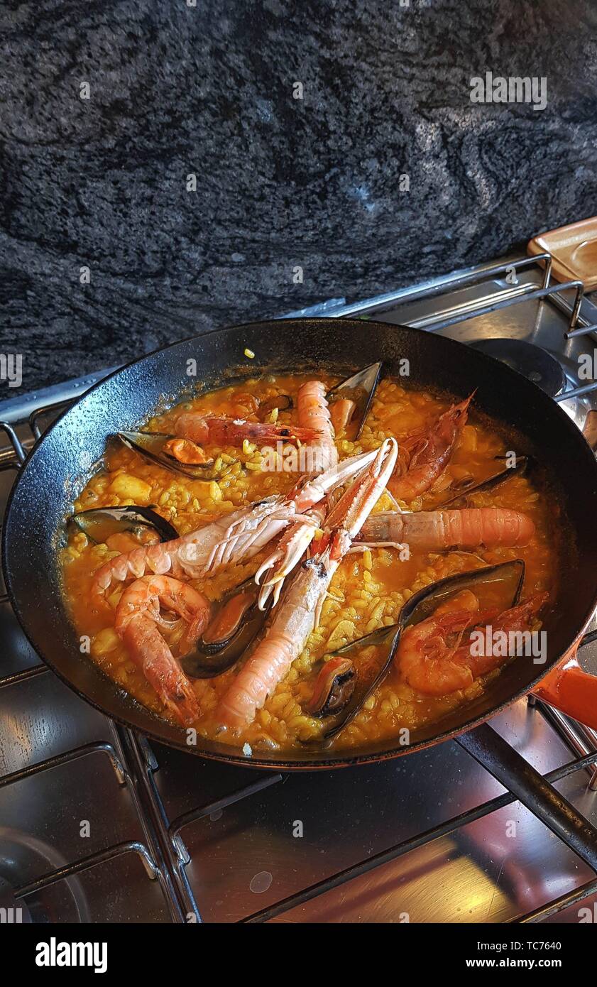 Paella. A Spanish dish prepared by simmering together chicken, seafood ...