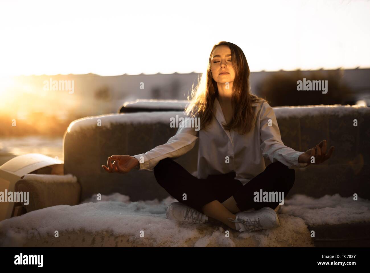 Woman meditating sitting calm winter hi-res stock photography and ...