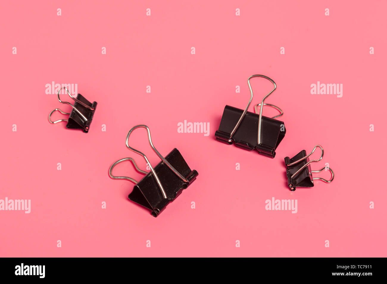 Office clips on bright pink background Stock Photo - Alamy